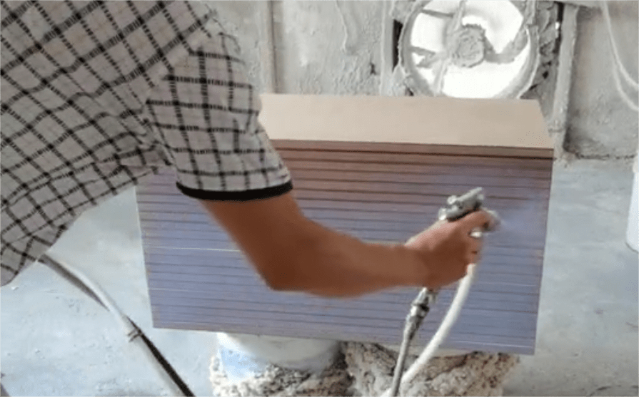 Vacuum membrane wrapping glue spraying process